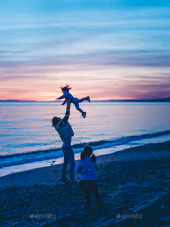dad rocking kid at the beach Stock Photo by ADDICTIVE_STOCK | PhotoDune