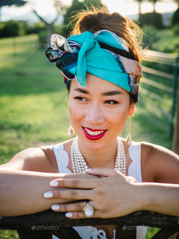 Young elegant chinese woman sunbathing Stock Photo by ADDICTIVE_STOCK