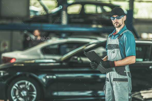 Car Dealership Technician Performing Car Maintenance Stock Photo by ...