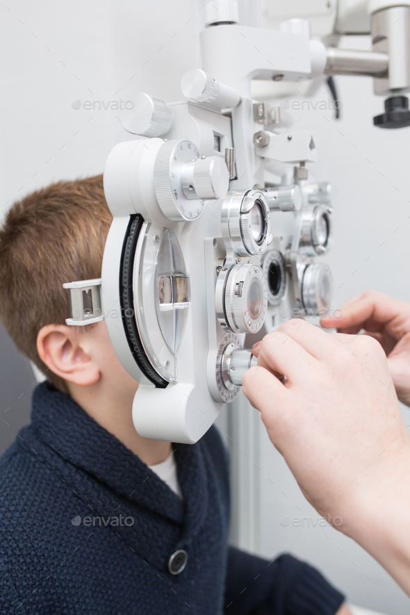 Optician testing a boy's eyes Stock Photo by ADDICTIVE_STOCK | PhotoDune