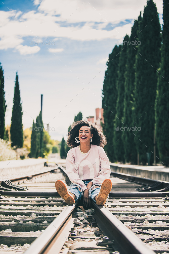 African-American woman laughing in the tracks of a train Stock Photo by ...