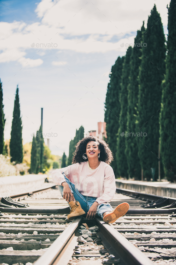 African-American woman laughing in the tracks of a train Stock Photo by ...