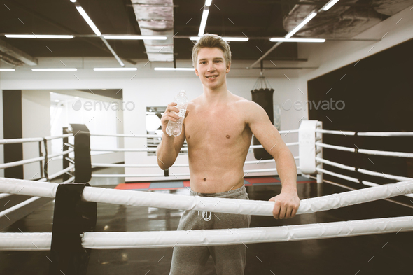 Male boxer drinking water after fight or workout exercising in boxing ...