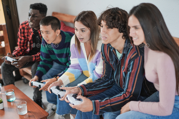 Young multiracial people playing video games at home - Generation z ...