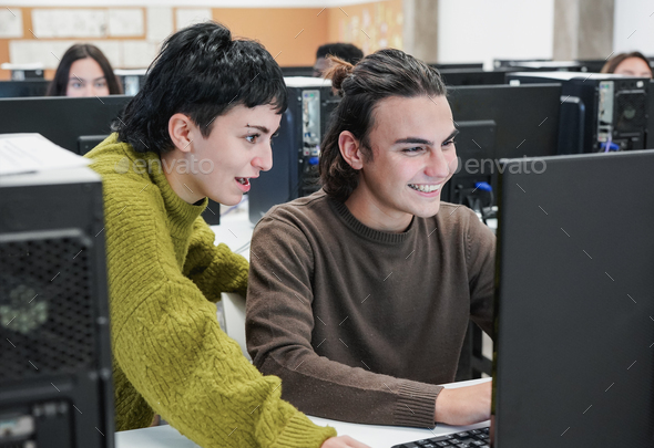 Young diverse students doing research at school inside computer ...