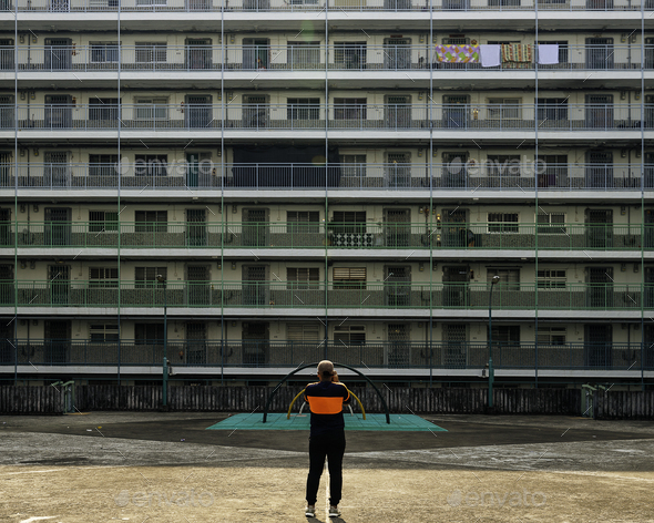 Back view of a man standing in front of a building Stock Photo by ...