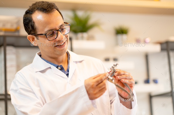 Close up optical staff or ophthalmologist hold special glasses that use ...