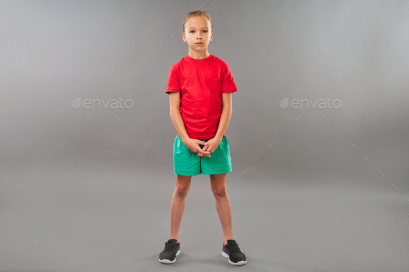 Cute female kid standing against gray background Stock Photo by friends ...