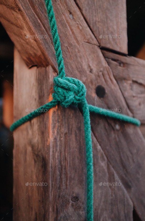 detail of a knot on a green rope tied around wooden timber Stock Photo ...