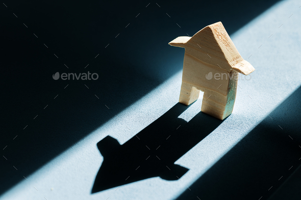 Miniature wooden house with shadows on blue background Stock Photo by ...