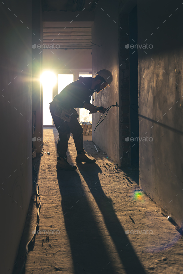 Worker is cutting wires with lineman's pliers. Stock Photo by puhimec