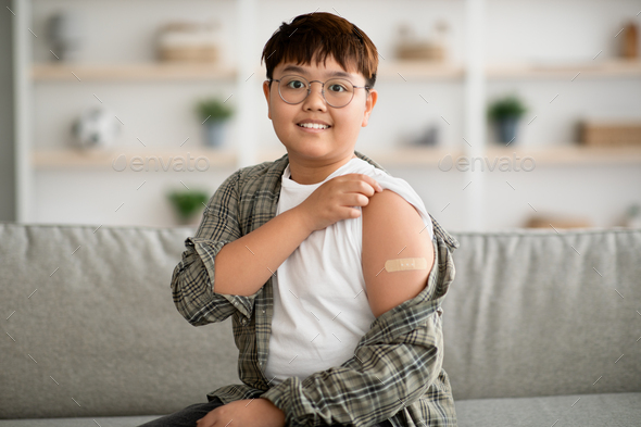 Cute plump korean kid got vaccinated, showing adhesive band Stock Photo ...