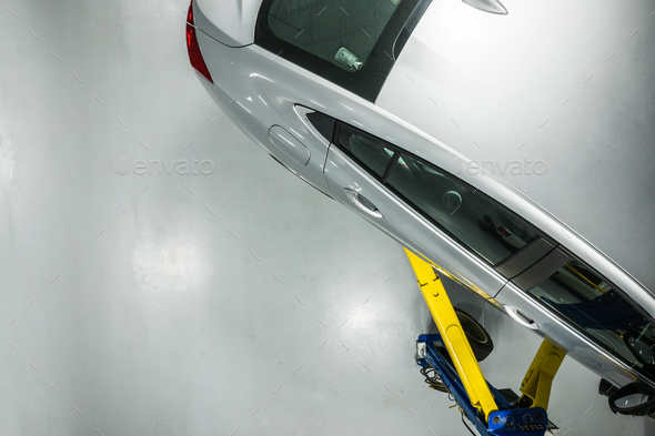 Modern Car on a Lift Inside an Auto Service Stock Photo by duallogic