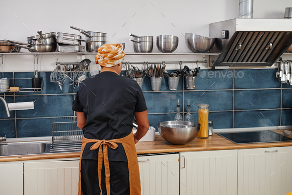 Back View Woman Cooking Stock Photo by seventyfourimages | PhotoDune