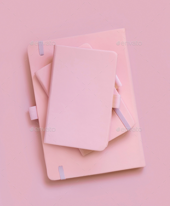 Stack of pink notebooks on light pink top view. Textbook mockup Stock ...