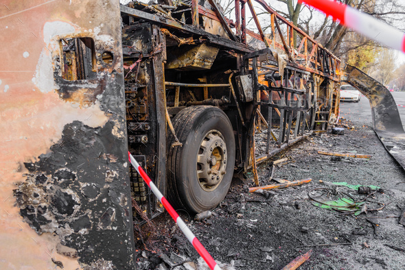 Burnt bus is seen on the street after caught in fire during travel ...