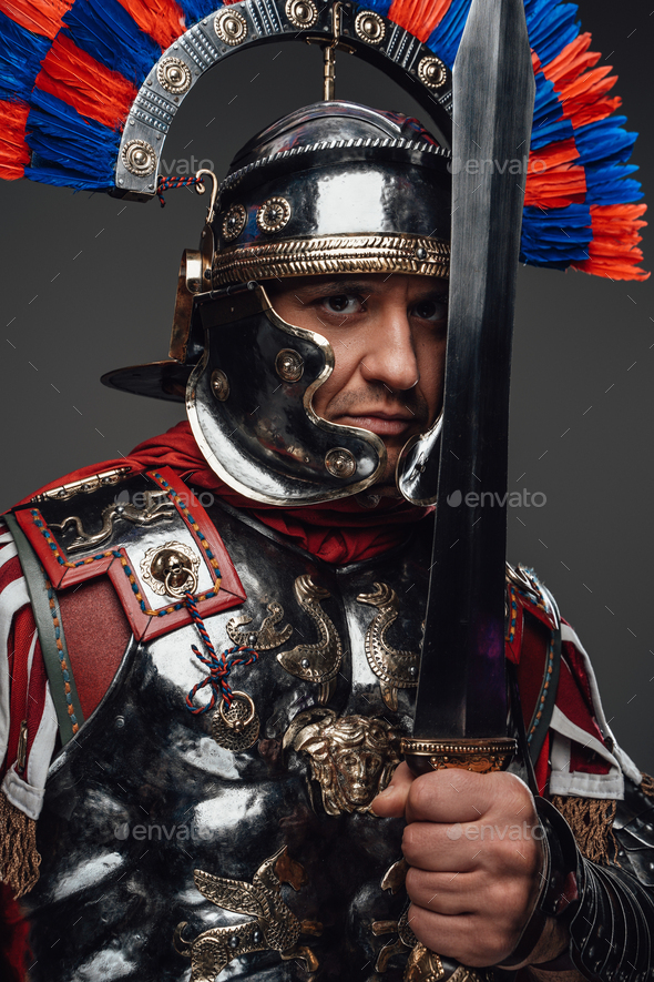 Roman legionnaire posing with sword isolated on gray Stock Photo by ...
