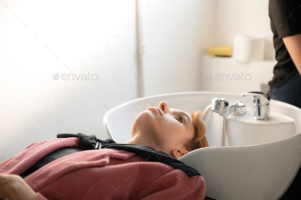 woman client person having a process to making treatment a hair with ...