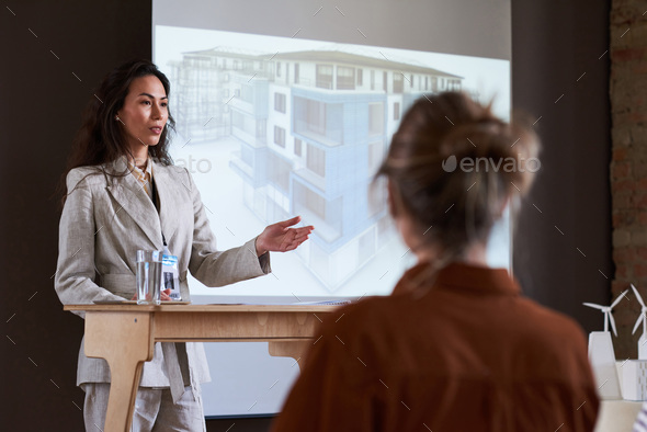Architect presenting new project of building Stock Photo by AnnaStills