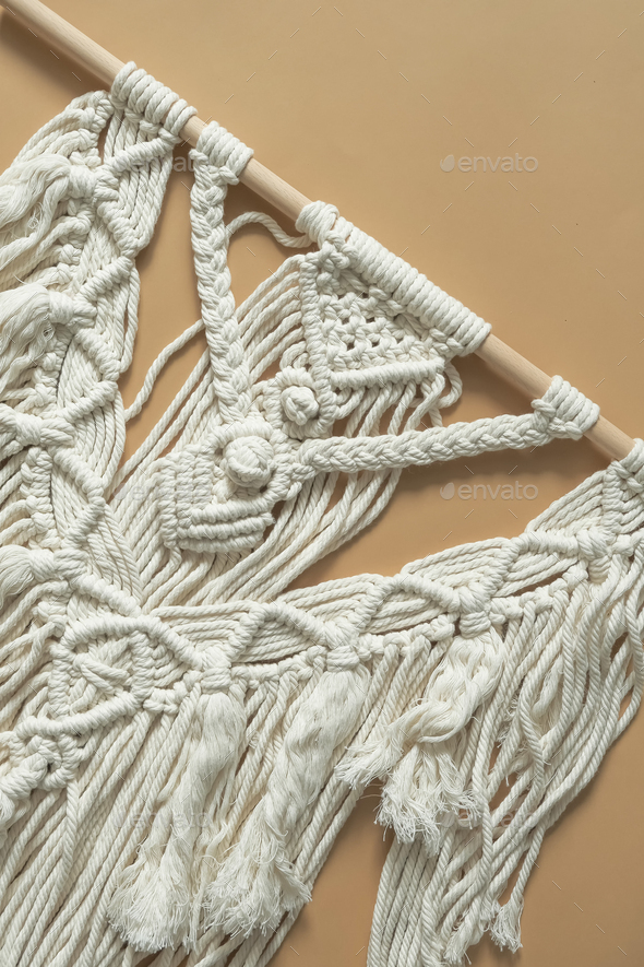 Macrame. Handmade macrame weaving and cotton threads on a rustic wooden ...