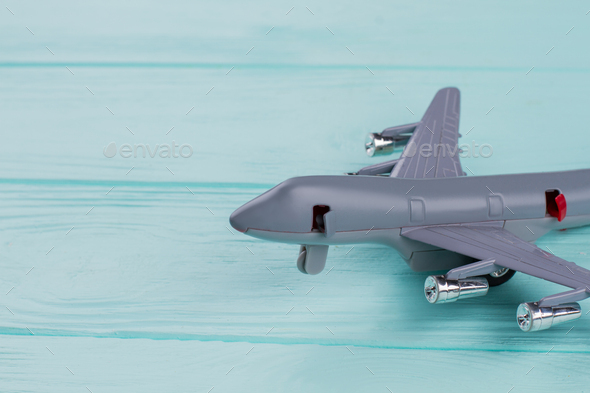 Close-up small grey toy airplane on turquoise background. Stock Photo ...