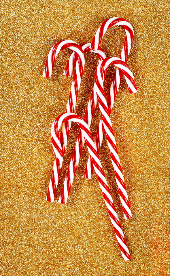 Candy canes on gold background. Christmas decoration Stock Photo by ...