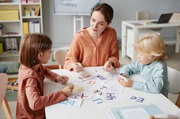 Children learning English with teacher Stock Photo by seventyfourimages