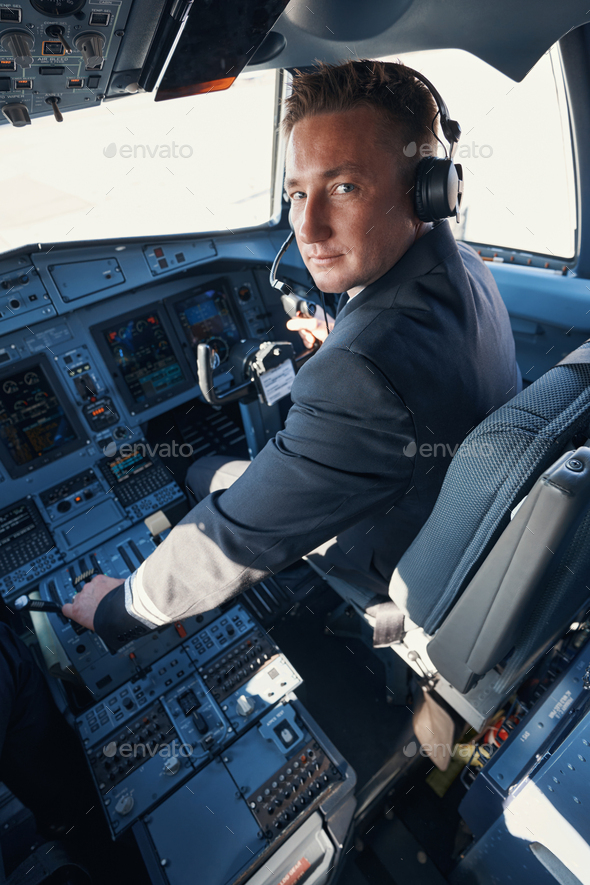 Professional co-pilot giving a look into camera from cockpit Stock ...