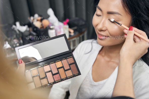 Unrecognized makeup artist making visage for client in salon Stock ...