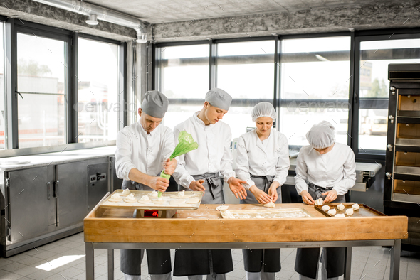 Bakers making buns at the manufacturing Stock Photo by RossHelen ...