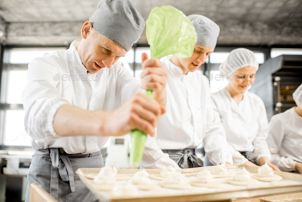 Bakers making buns at the manufacturing Stock Photo by RossHelen ...
