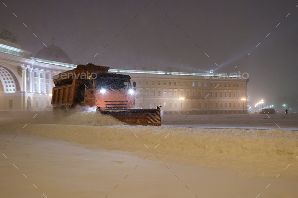 Snow storm in city. Snowplow trucks work at night during winter season ...