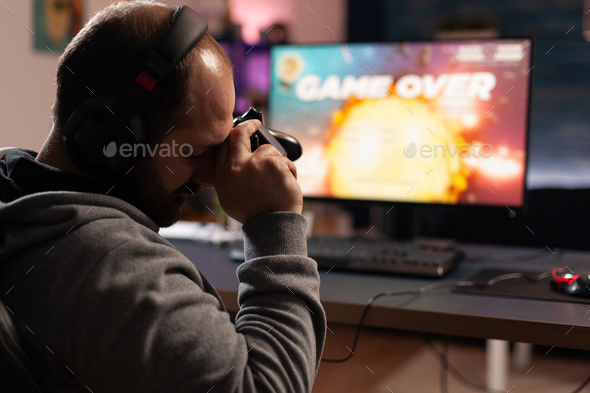 Sad man losing video games after playing with joystick Stock Photo by ...