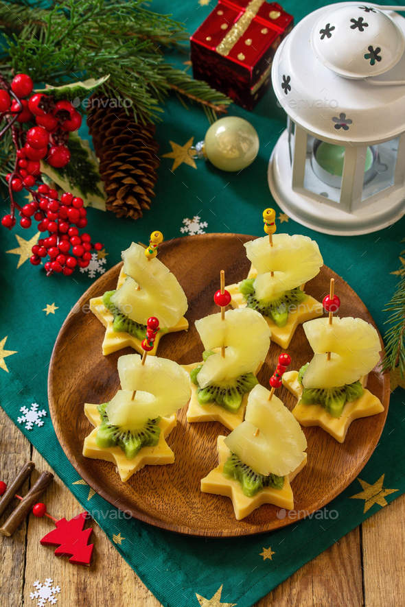Festive snack of canapes on the Christmas table. Fruit canapes with ...