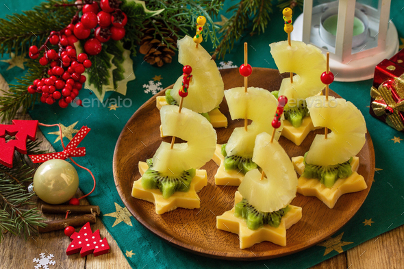 Festive snack of canapes on the Christmas table. Fruit canapes with ...