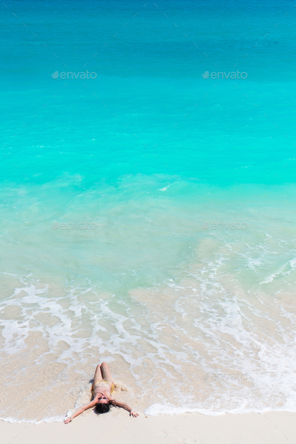 Top view of beautiful girl in shallow water Stock Photo by travnikovstudio