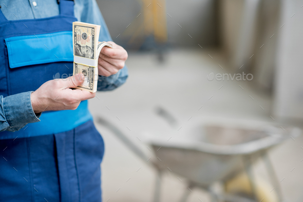 Builder counting money Stock Photo by RossHelen | PhotoDune