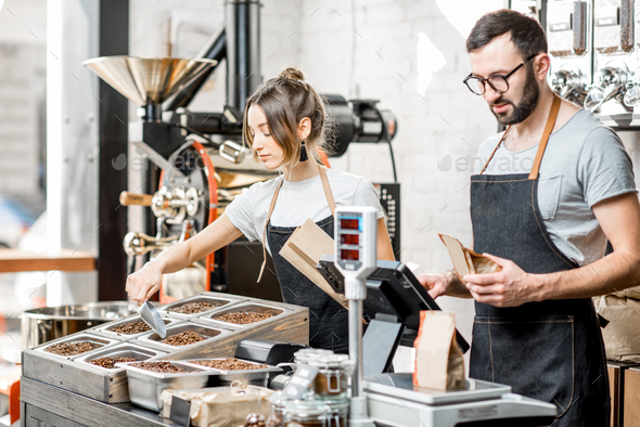 Coffee sellers working in the shop Stock Photo by RossHelen | PhotoDune