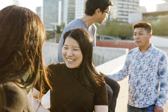 Group of asian friends talking on the street. Focus on chinese woman ...