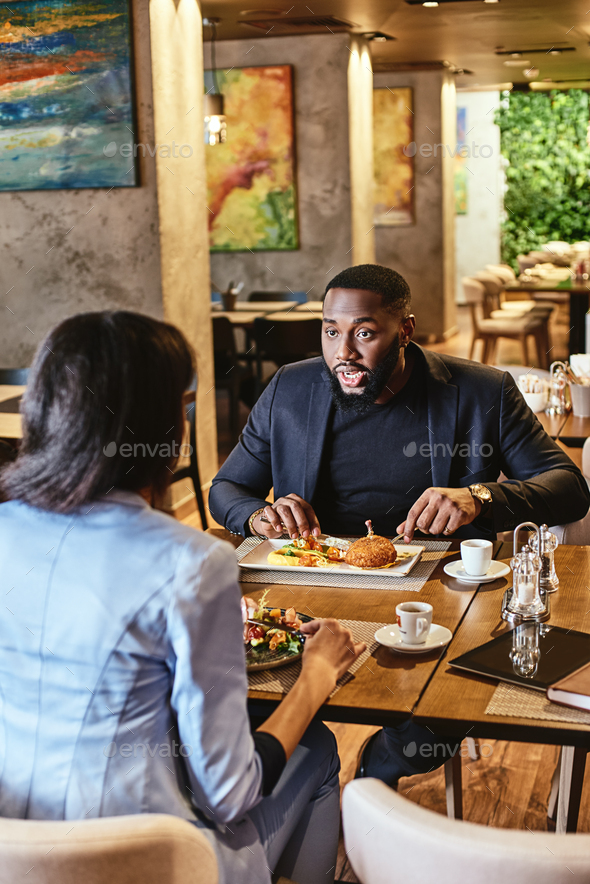 Getting the Most Out of Lunch. Two colleagues having lunch in company's ...