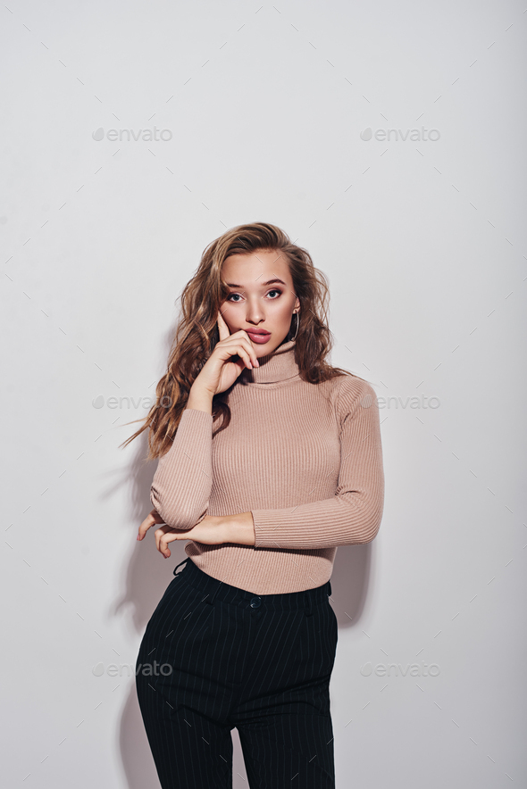 How much longer Beautiful girl with tired look posing in studio ...