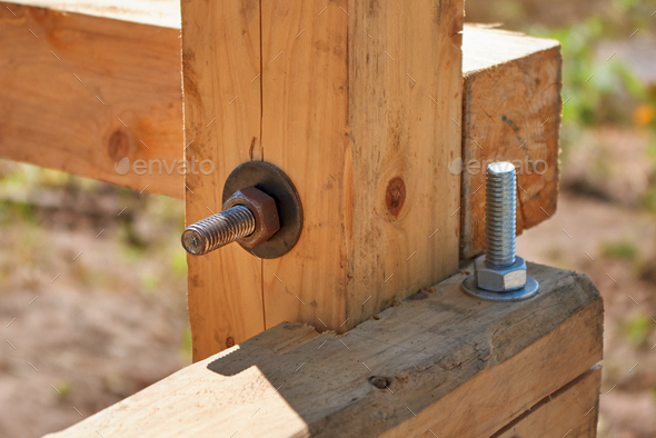 Nuts and bolts hold the joints of the wood together Stock Photo by ...