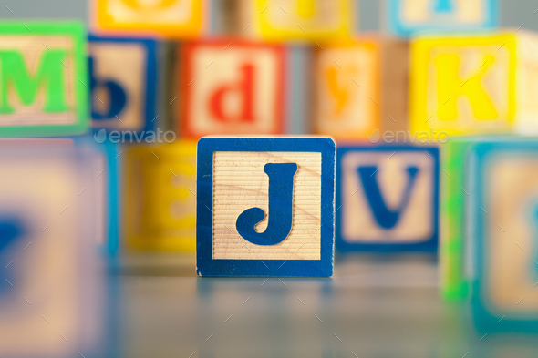 Photograph of colorful Wooden Block Letter J Stock Photo by FabrikaPhoto