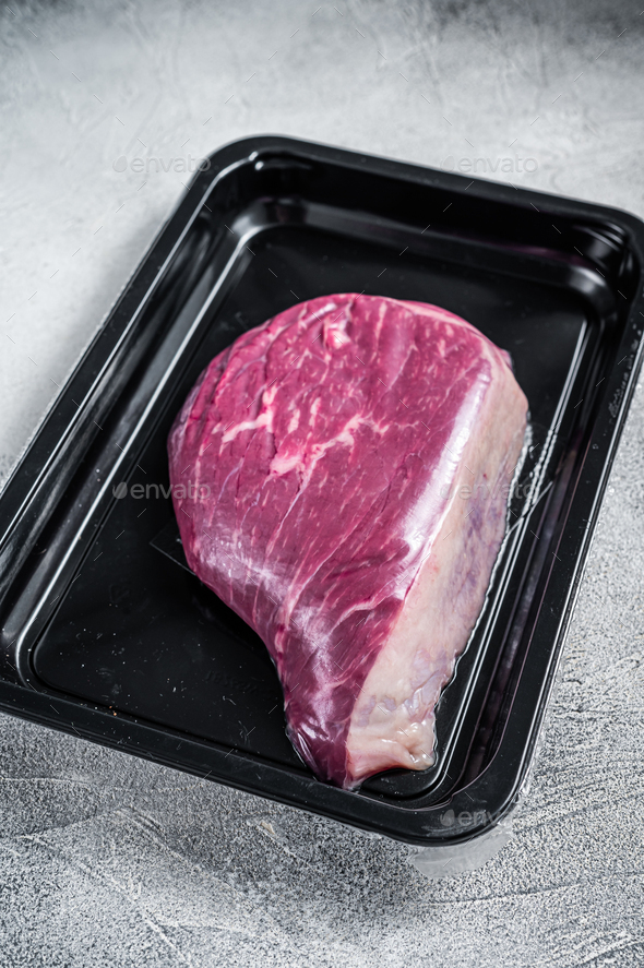 Raw cap rump steak or top sirloin beef meat steak in vacuum packaging ...