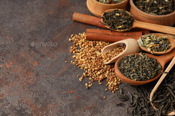 Concept of cooking tea with different types of tea on dark textured ...