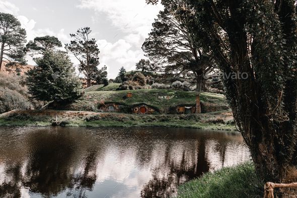 Cozy yard near hobbit burrow near river Stock Photo by ADDICTIVE_STOCK
