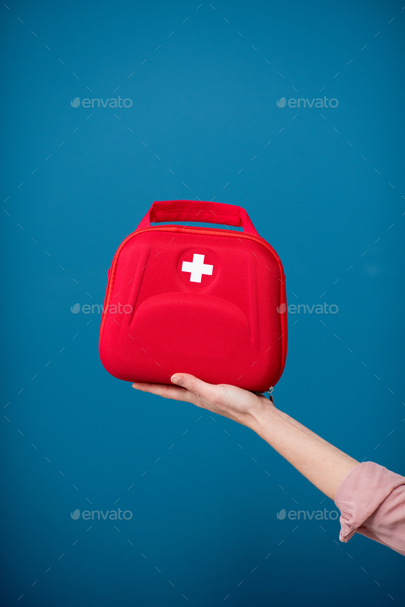 First aid kit on the blue background Stock Photo by RossHelen | PhotoDune