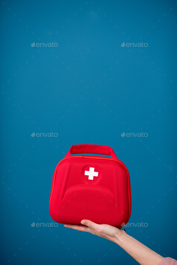 First aid kit on the blue background Stock Photo by RossHelen | PhotoDune