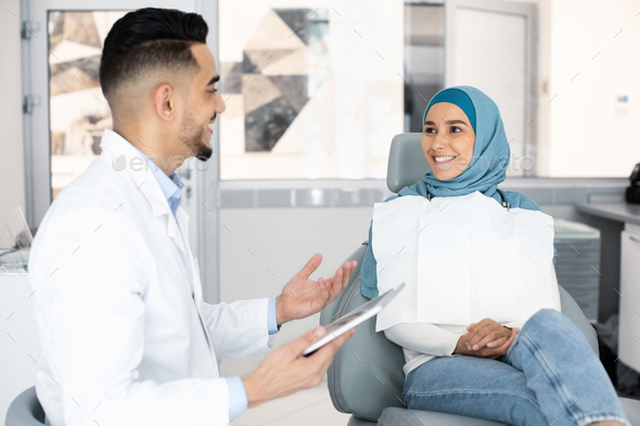 Middle Eastern Dentist And Muslim Female Patient Talking During Checkup ...