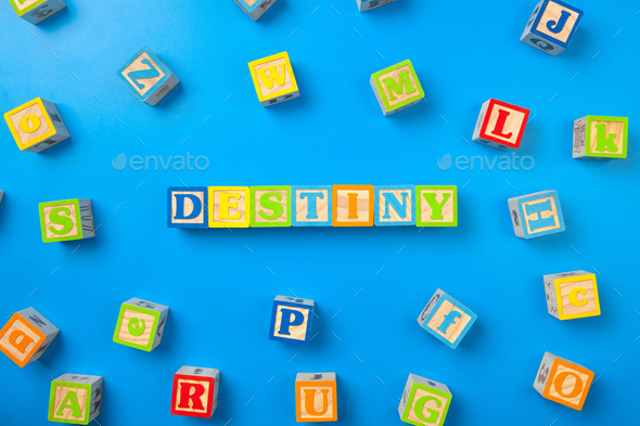 Destiny. Wooden colorful alphabet blocks on blue background, flat lay ...